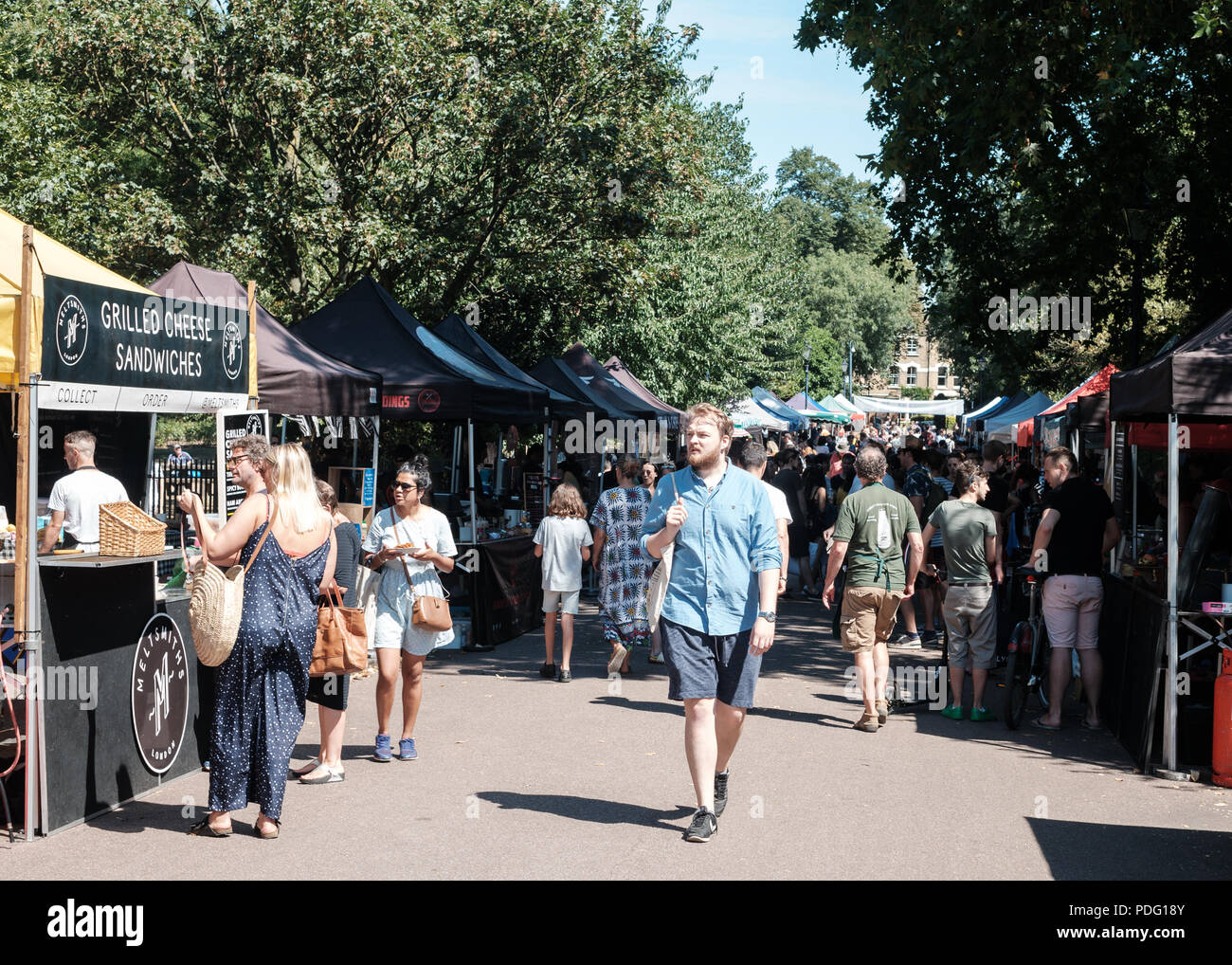 Shoppers and stalls in Victoria Park food market, held along the ...