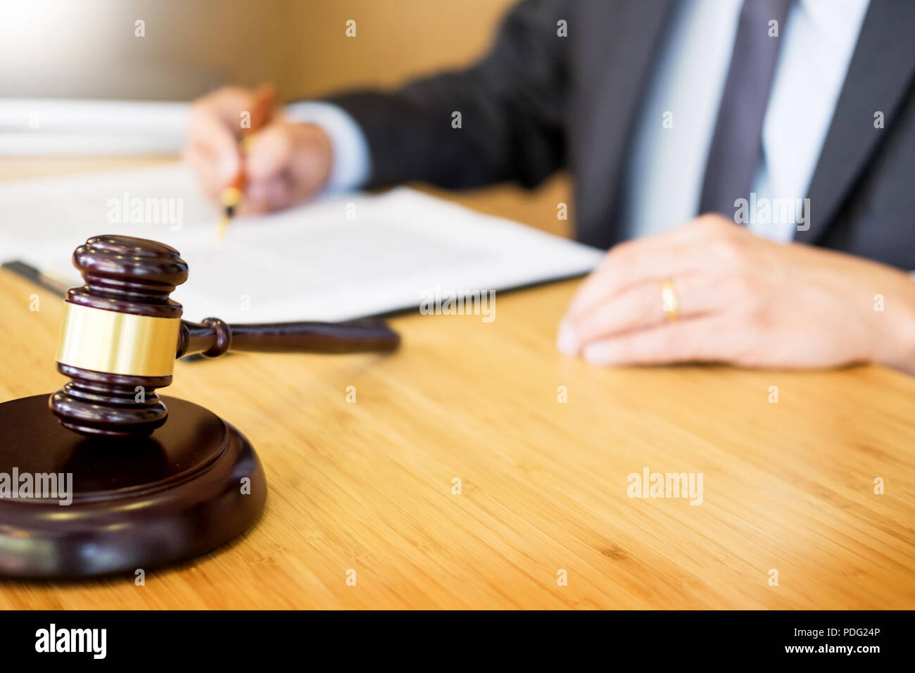 lawyer judge reading documents at desk in courtroom working on wooden ...