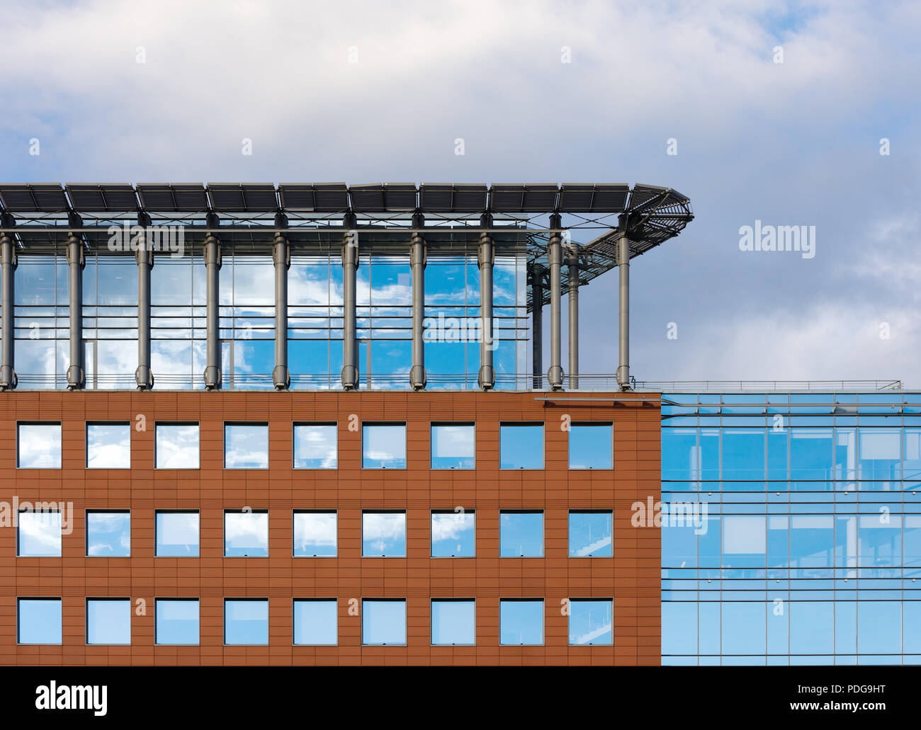 Facade of a modern office building. Square windows, attic floor and ...