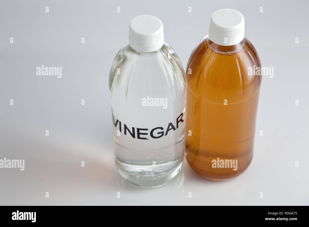 white vinegar and apple cider vinegar on white background Stock Photo ...