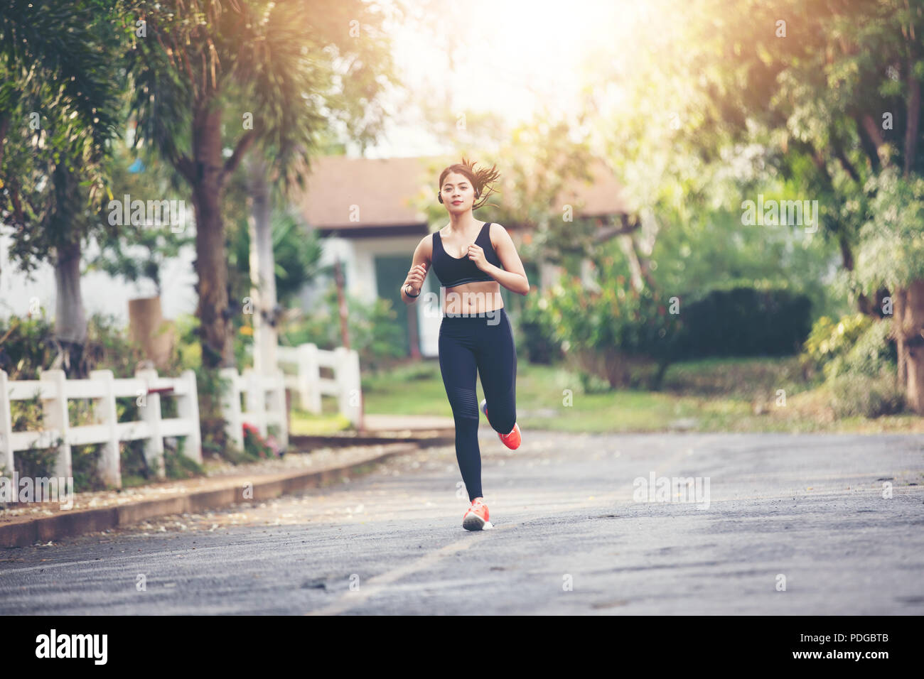 Running woman. Female runner jogging during outdoor on road .Young ...