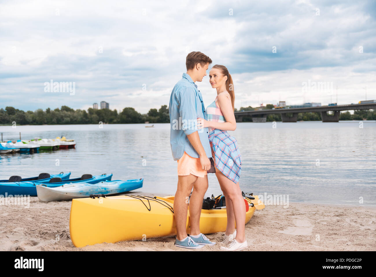 Beautiful young couple having romantic date near the river Stock Photo ...