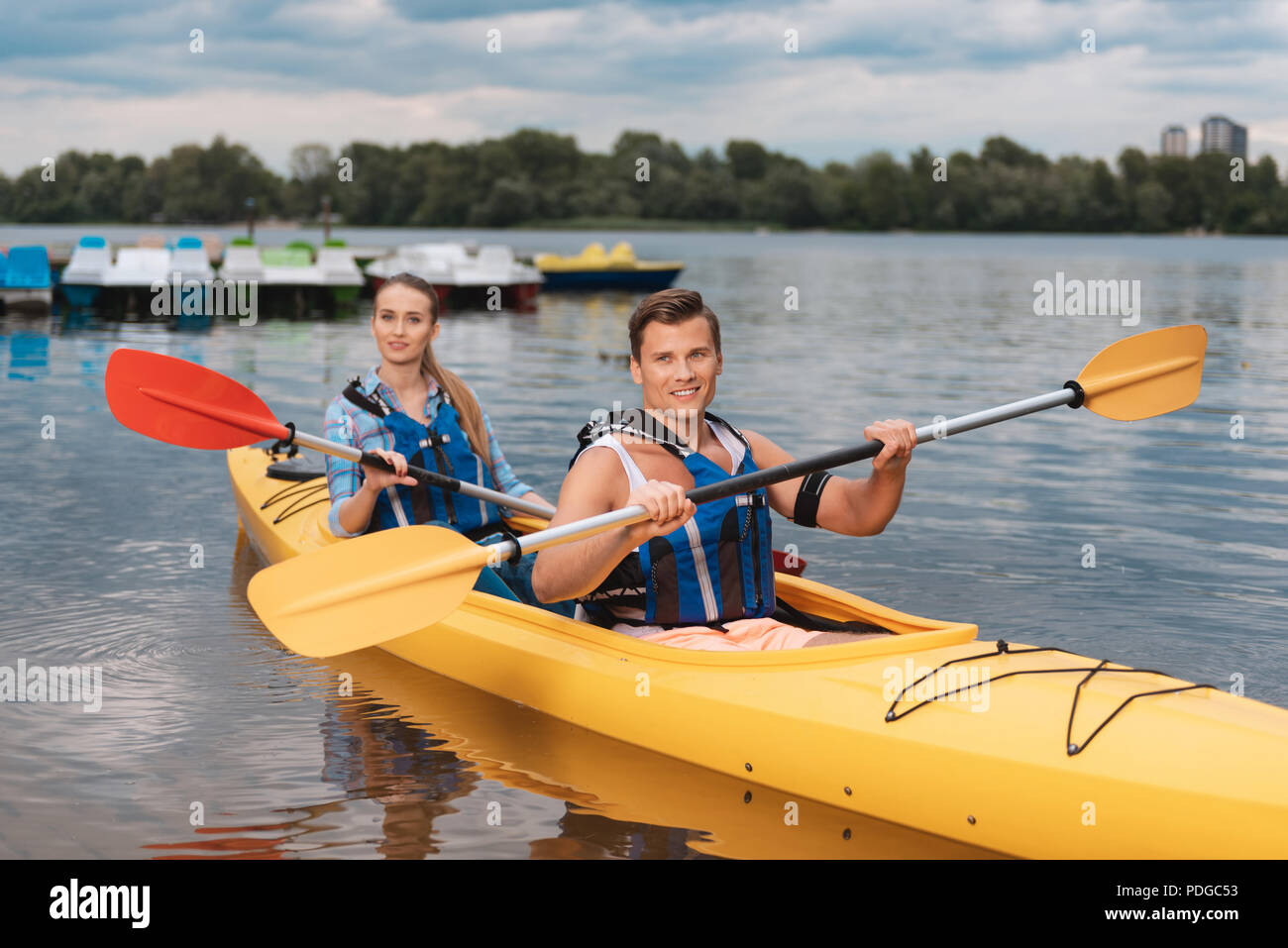 Active couple enjoying river kinds of sport kayaking together Stock ...