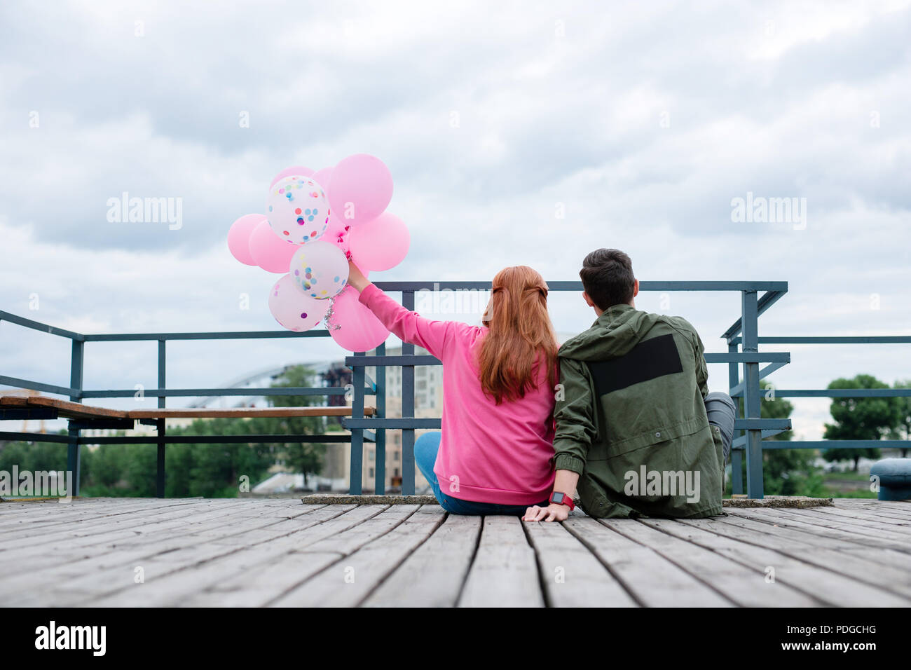 Couple sitting pier beautiful hi-res stock photography and images - Alamy