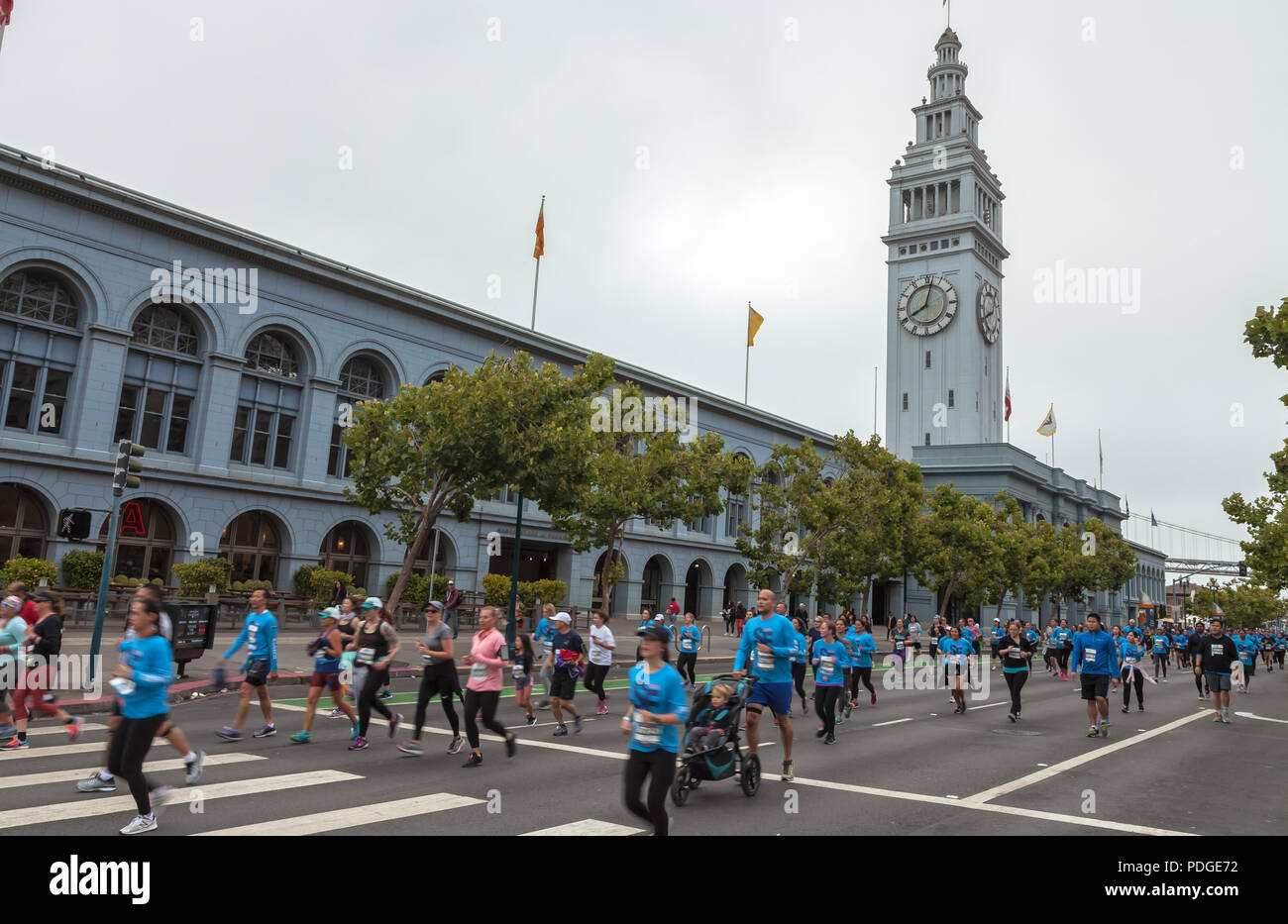 Runners for the 5K race were passing by the Ferry Building to head back ...