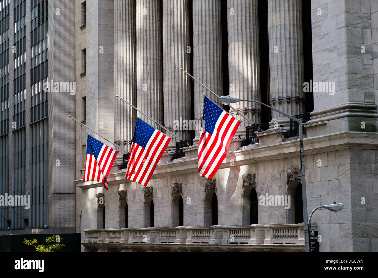 Backlit flags in front of the portico of New York Stock Exchange, Wall ...