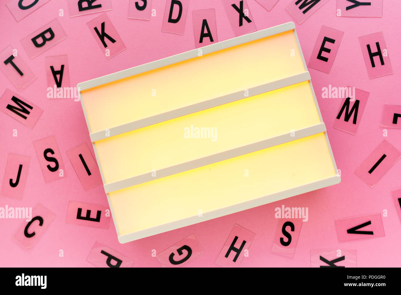 Blank lightbox and letters on girly pink background, mock up copy space ...