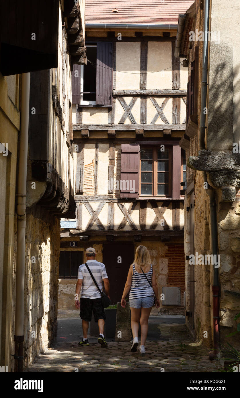 Tourist couple exploring the narrow streets of medieval Bergerac old ...