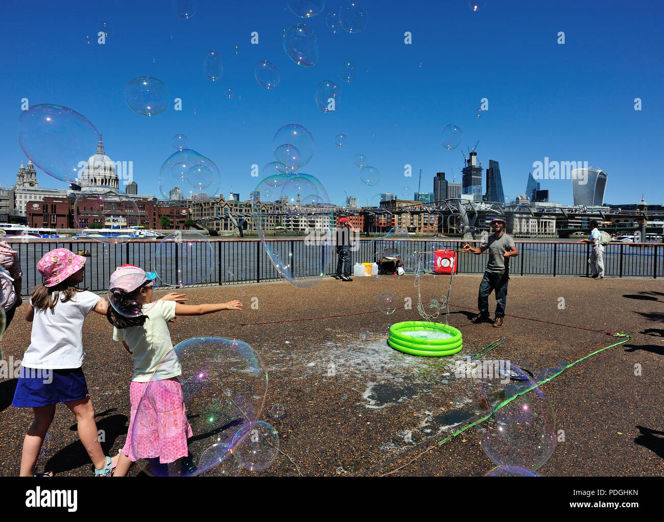 Children having fun with bubbles, Southbank, London, England, UK Stock ...