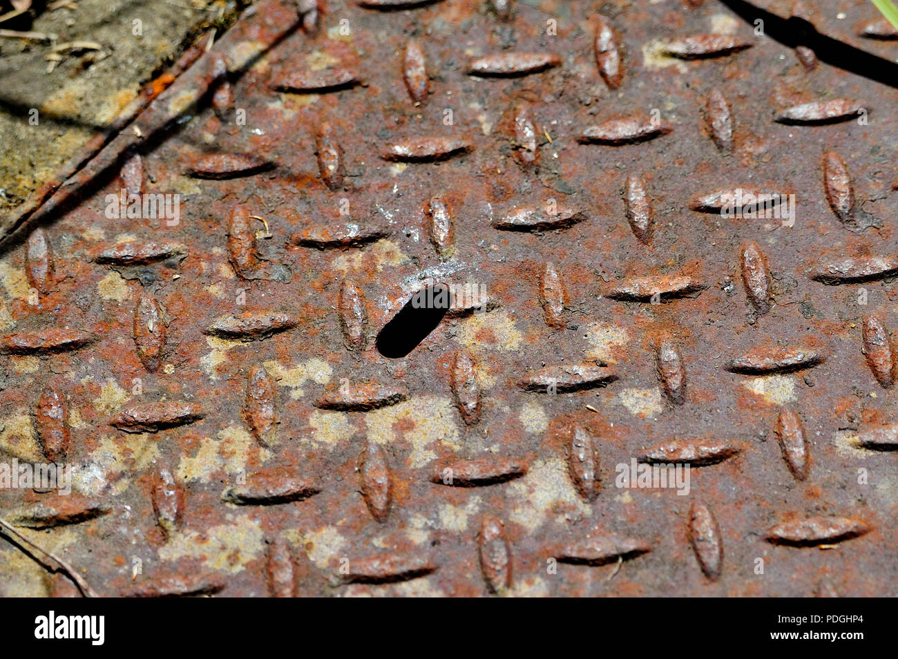 rusty iron manhole drain cover Stock Photo - Alamy