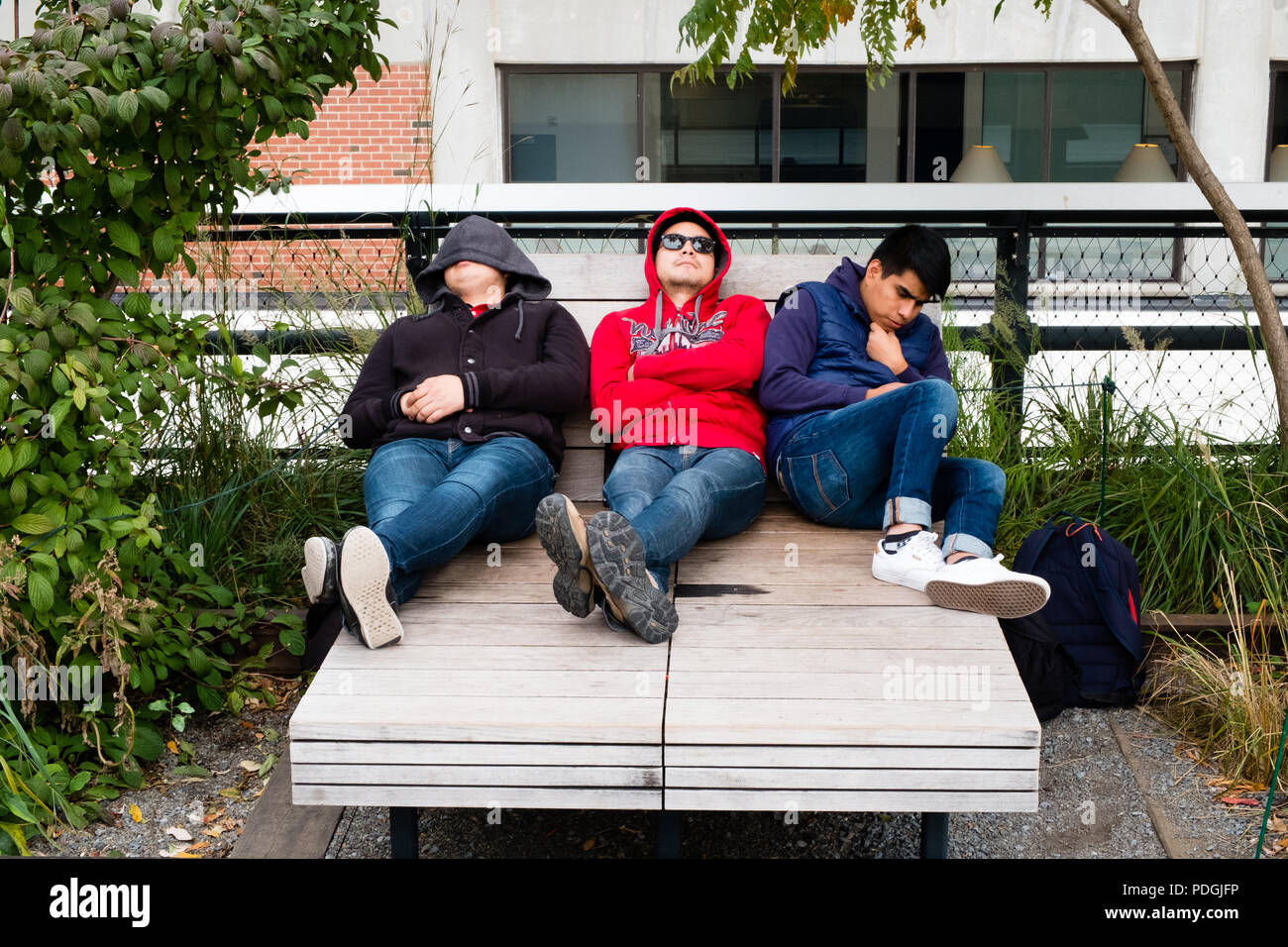 Three men sleeping on a bench Stock Photo - Alamy