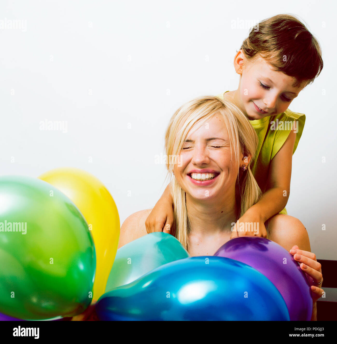 pretty real family with color balloons on white background, blon Stock ...
