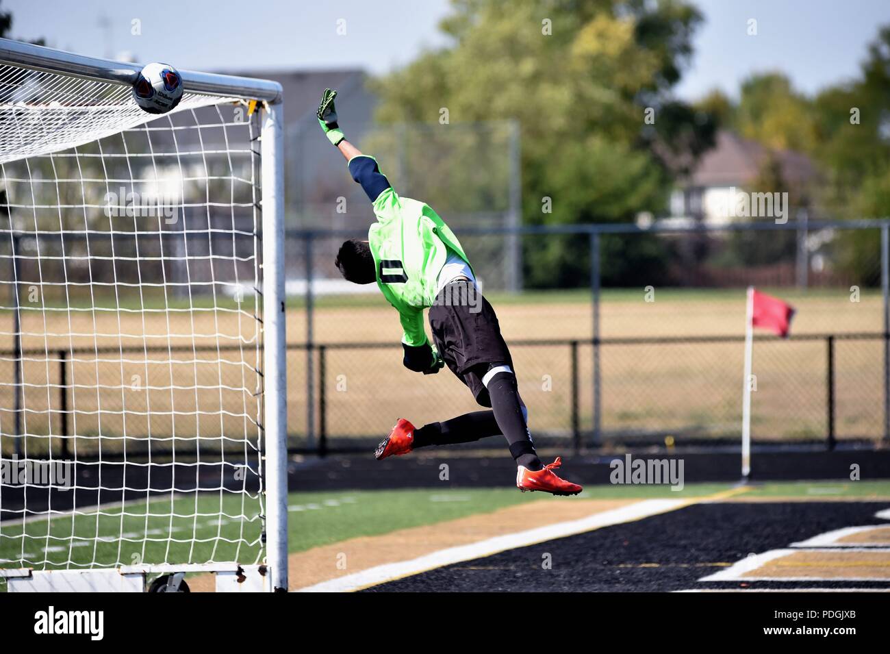 Keeper deflecting a shot that resulted in the ball rebounding off the ...