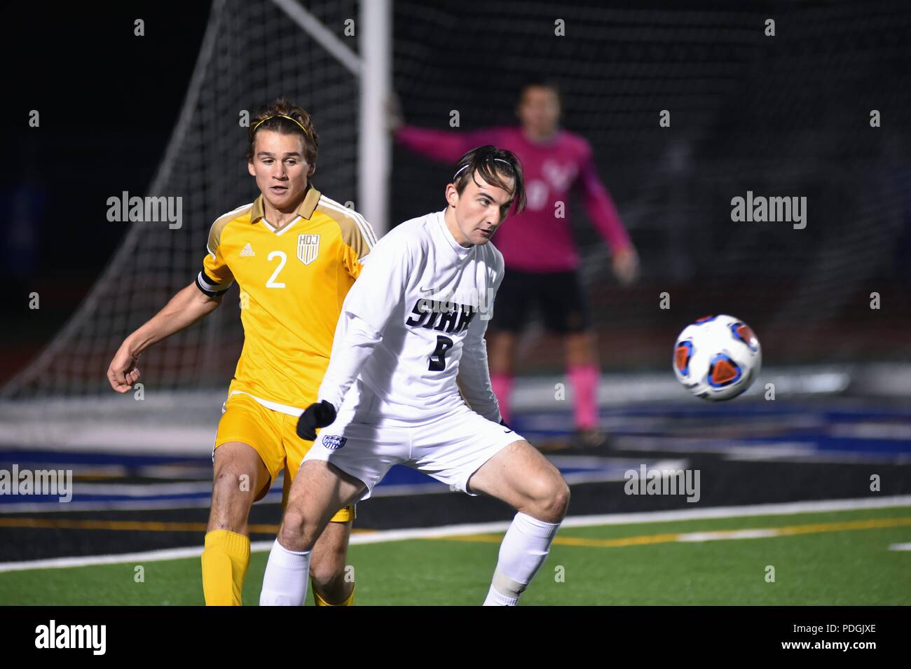Player pivoting near the opposing goal in front of a defender as his ...
