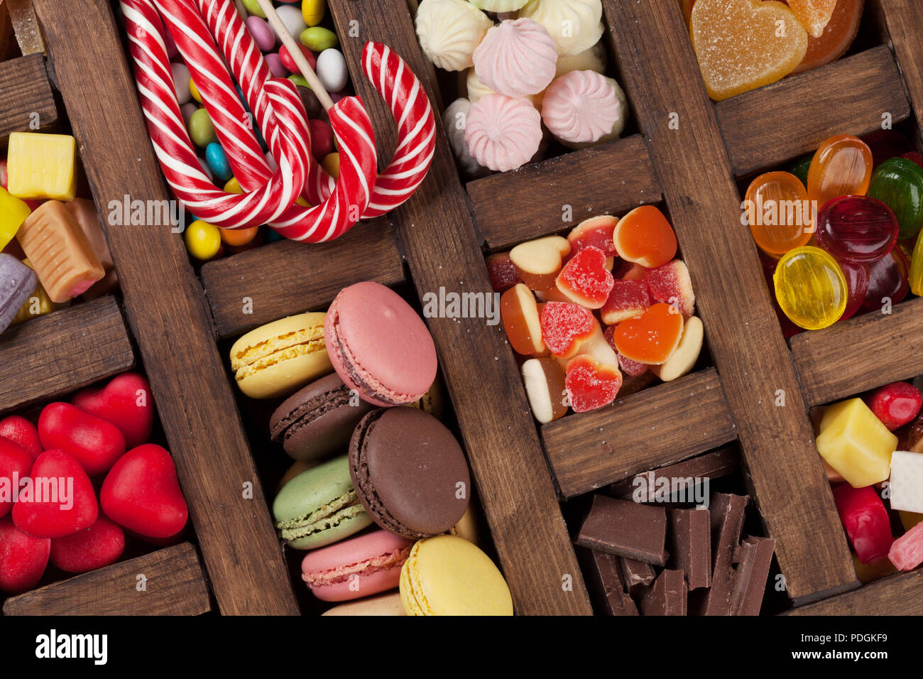 Colorful sweets box. Lollipops, macaroons, marshmallow, marmalade and ...