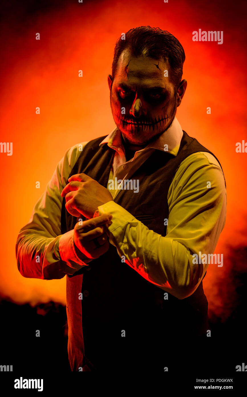 Portrait of a nicely dressed man with skull makeup. Horror and ...