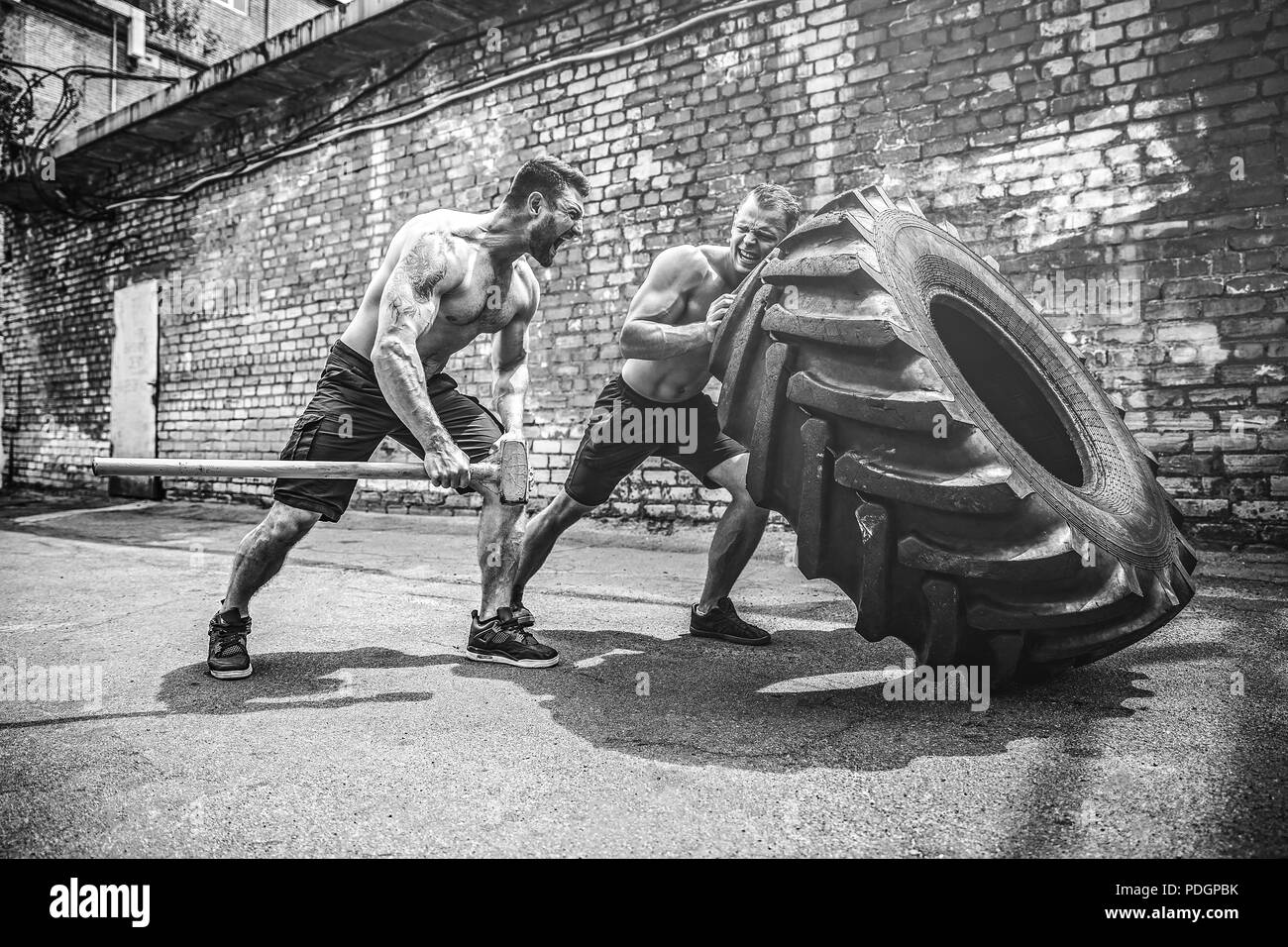 Two muscular athletes training. Muscular fitness shirtless man moving ...