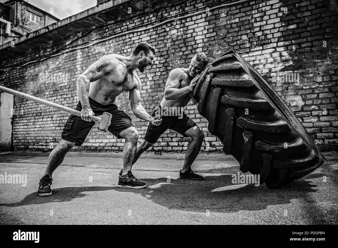 Two muscular athletes training. Muscular fitness shirtless man moving ...