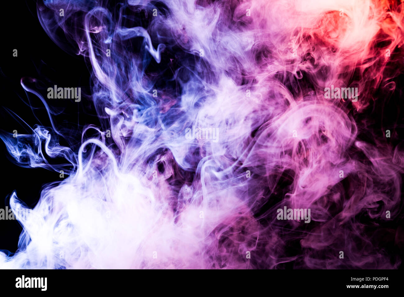 Cloud of pink, purple, blue smoke on a black isolated background ...