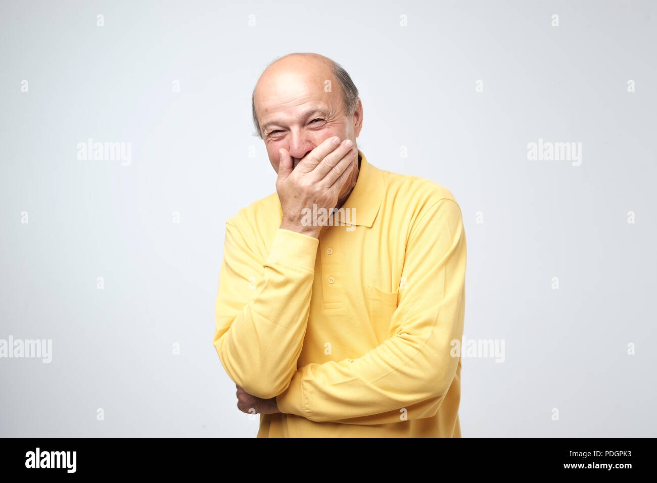Man hand over mouth laughing hi-res stock photography and images - Alamy
