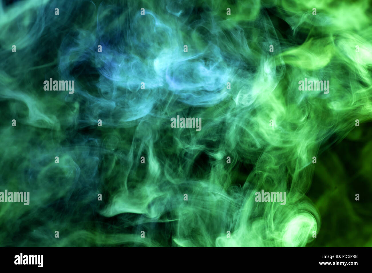Thick blue and green smoke on a black isolated background. Background ...