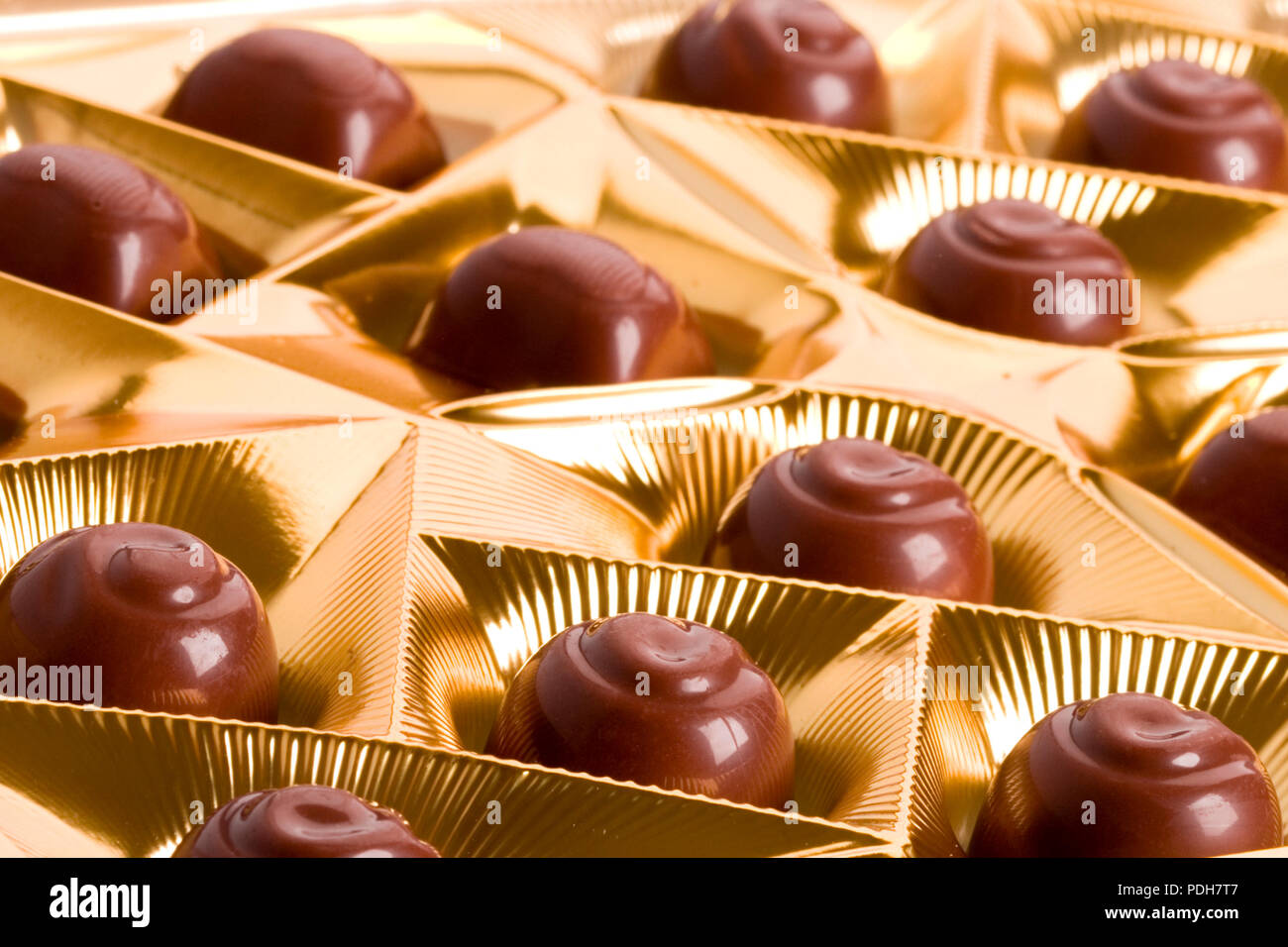 chocolate sweets in golden box closeup Stock Photo - Alamy