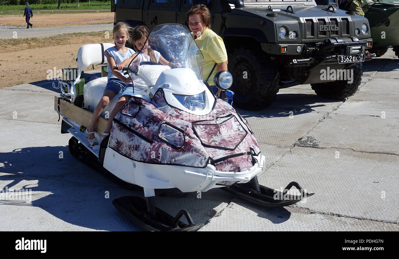 Pskow, Russia. 07th Aug, 2018. Children sit on an exhibited snowmobile ...