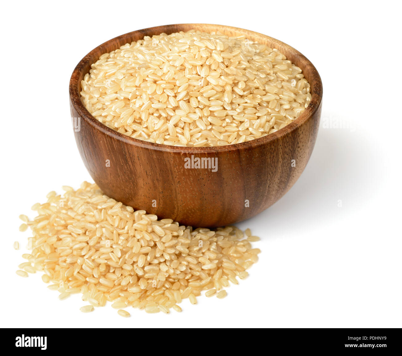 uncooked brown rice in the wooen bowl, isolated on white background ...
