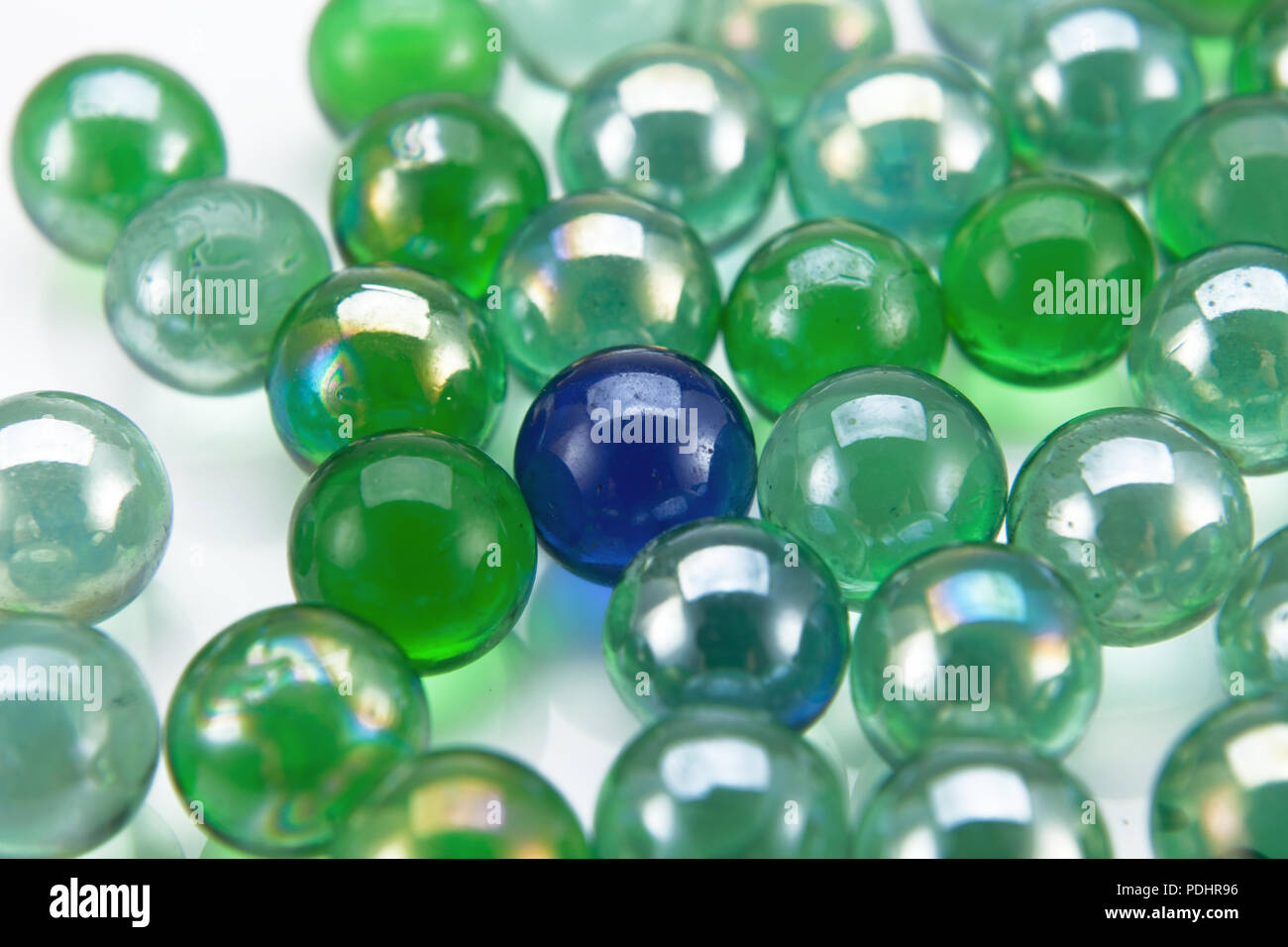 blue marbles stand out from the crowd from a variety of colors isolated ...