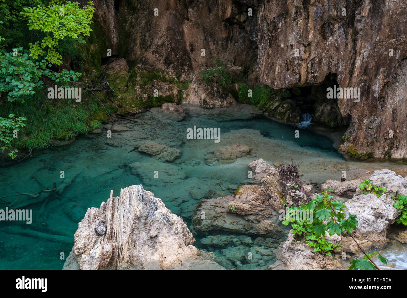 Croatia, Europe: rocks, cave and lake at Plitvice Lakes National Park ...