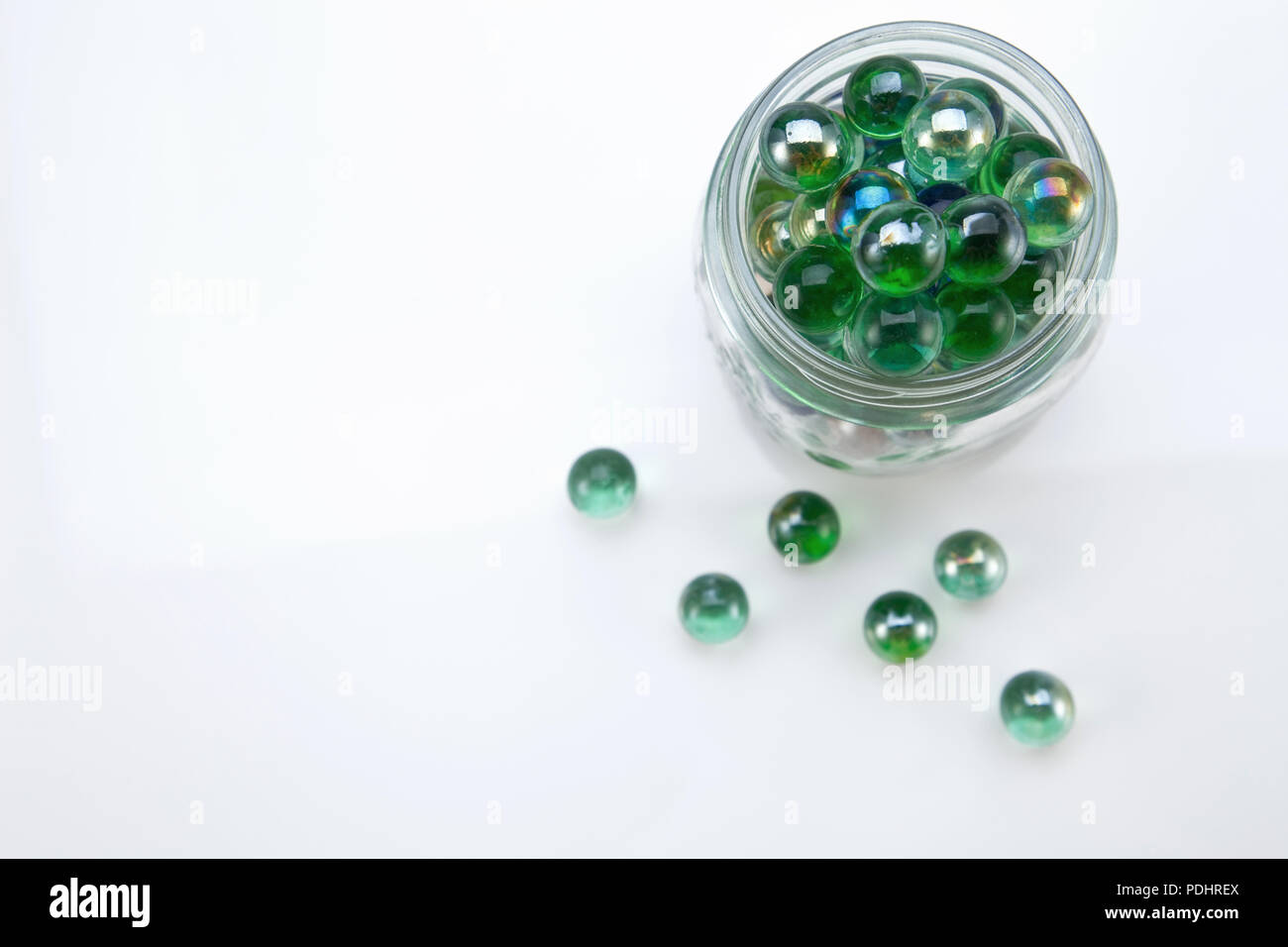 group of marbles in a variety of colors isolated on a white background ...