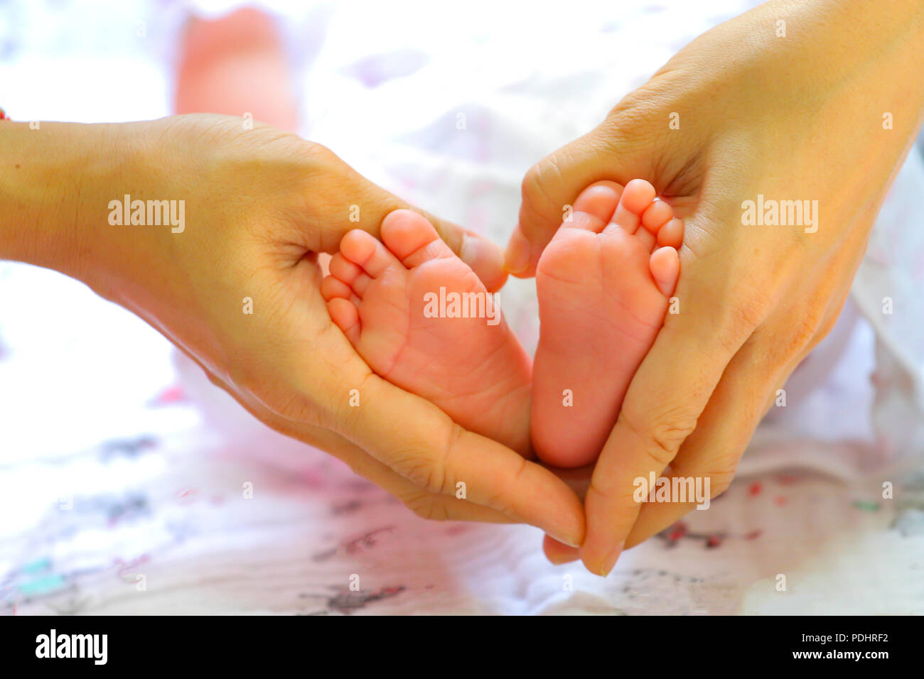 heart shape with the new born legs Stock Photo - Alamy