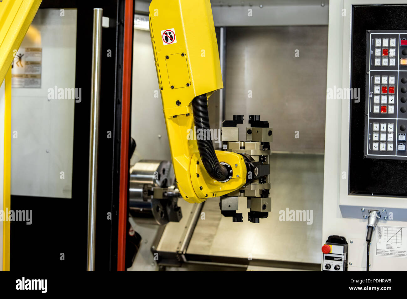 Robot hand with gripper operating with CNC machine Stock Photo - Alamy