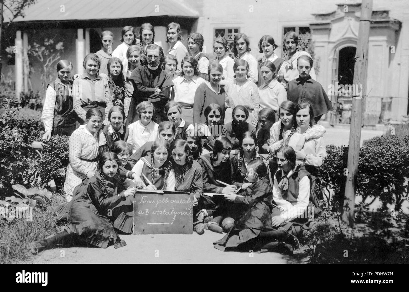 Class photo with the priest Black and White Stock Photos & Images - Alamy