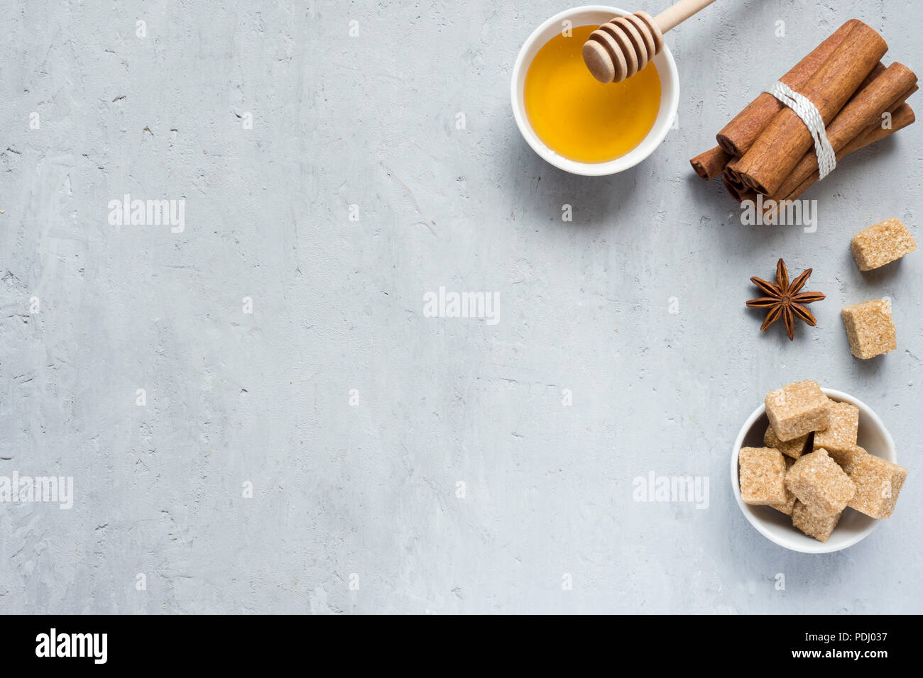 Honey, brown sugar and star anise with cinnamon on light background ...