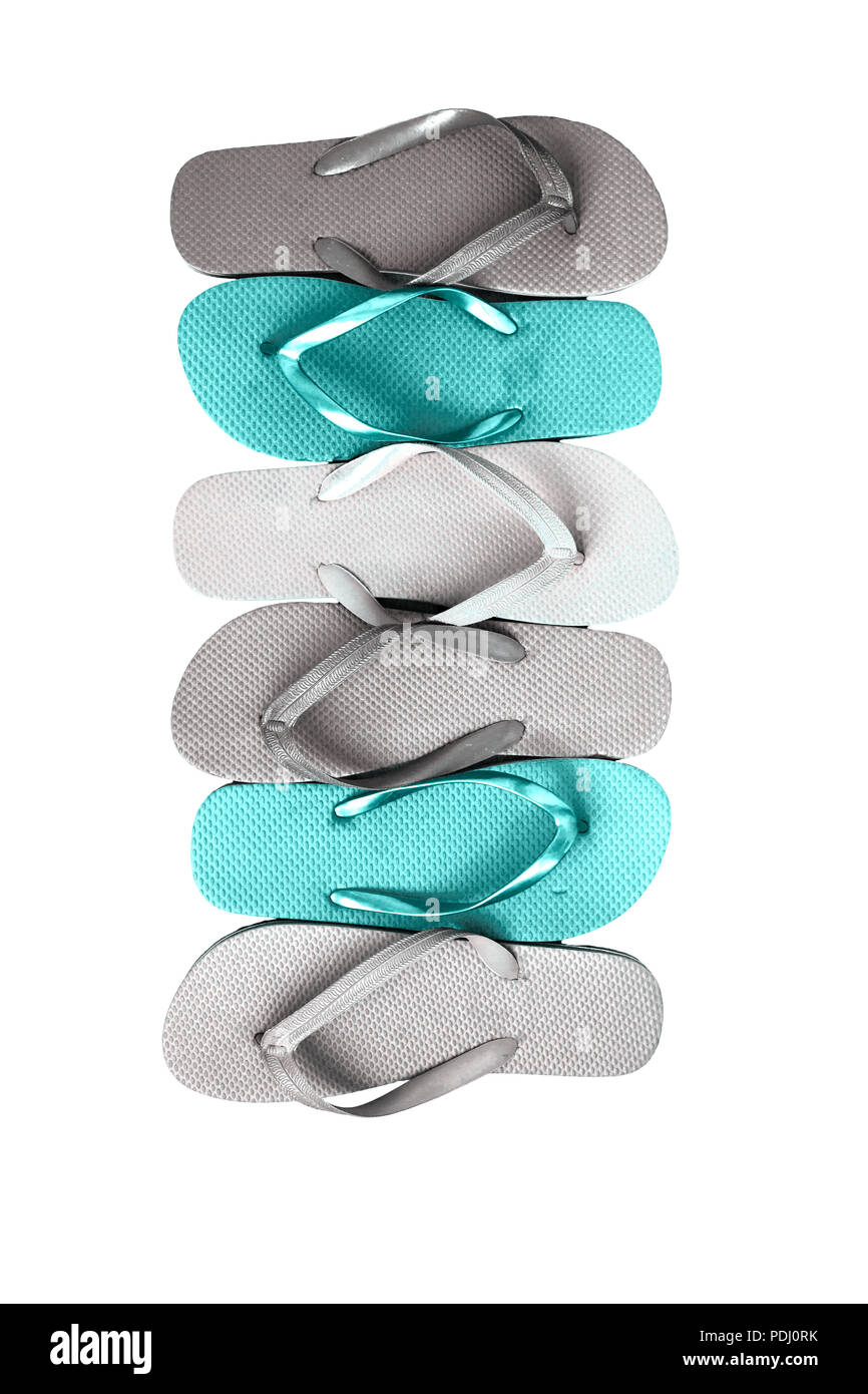 Several pairs of multi-colored rubber flip-flops exhibited in a row ...
