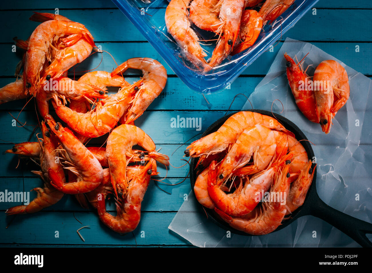 Top view of blue wooden table full of prawns ready to cook Stock Photo ...