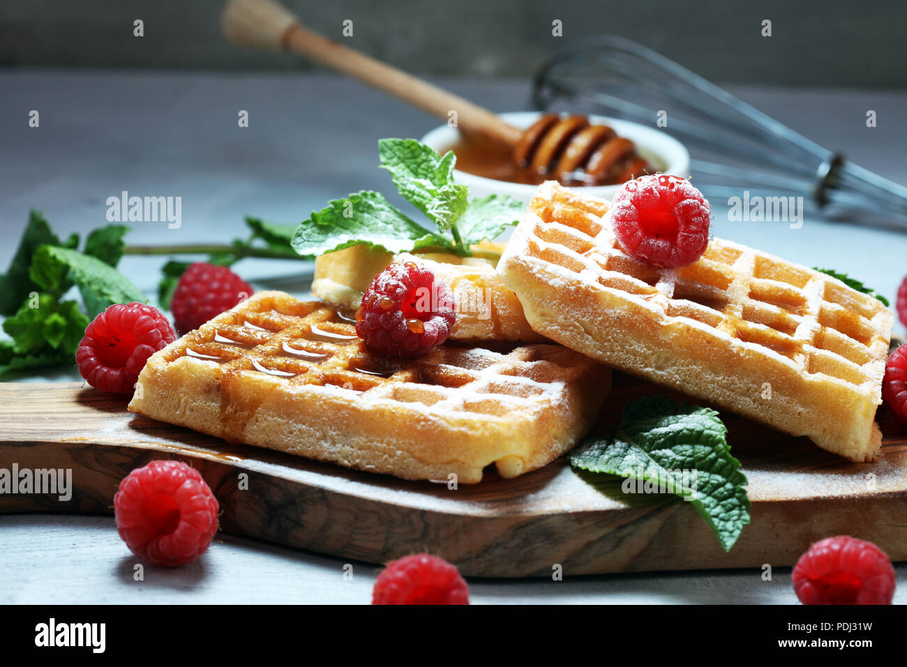 Traditional belgian waffles with fresh mint, sugar and raspberries ...