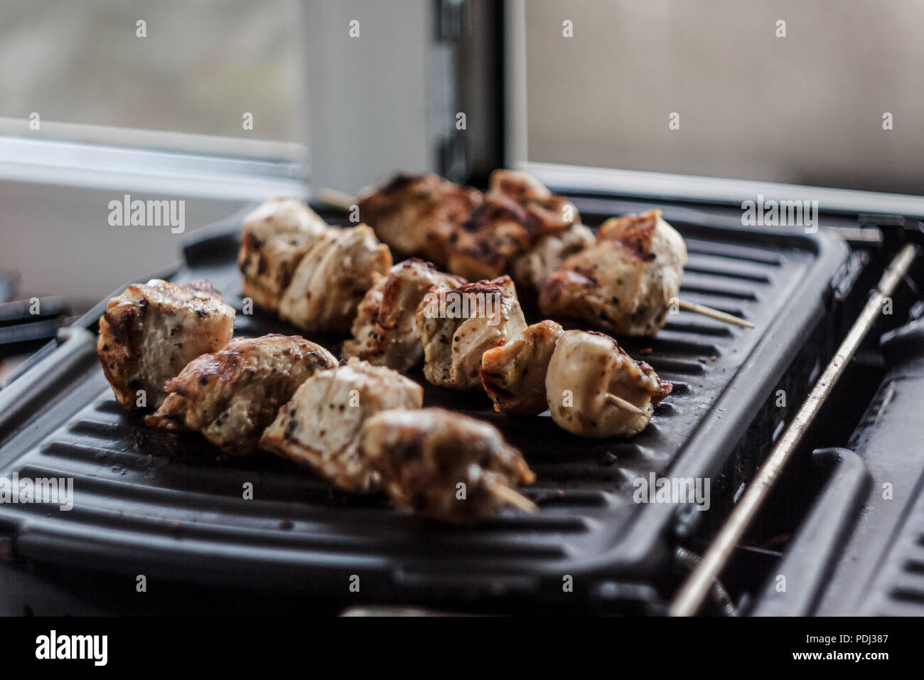 Pork-beef shish kebab prepared on a home electric grill Stock Photo - Alamy