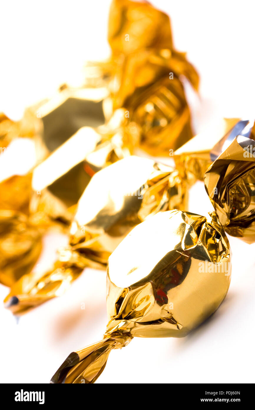 golden sweets closeup on white background Stock Photo - Alamy