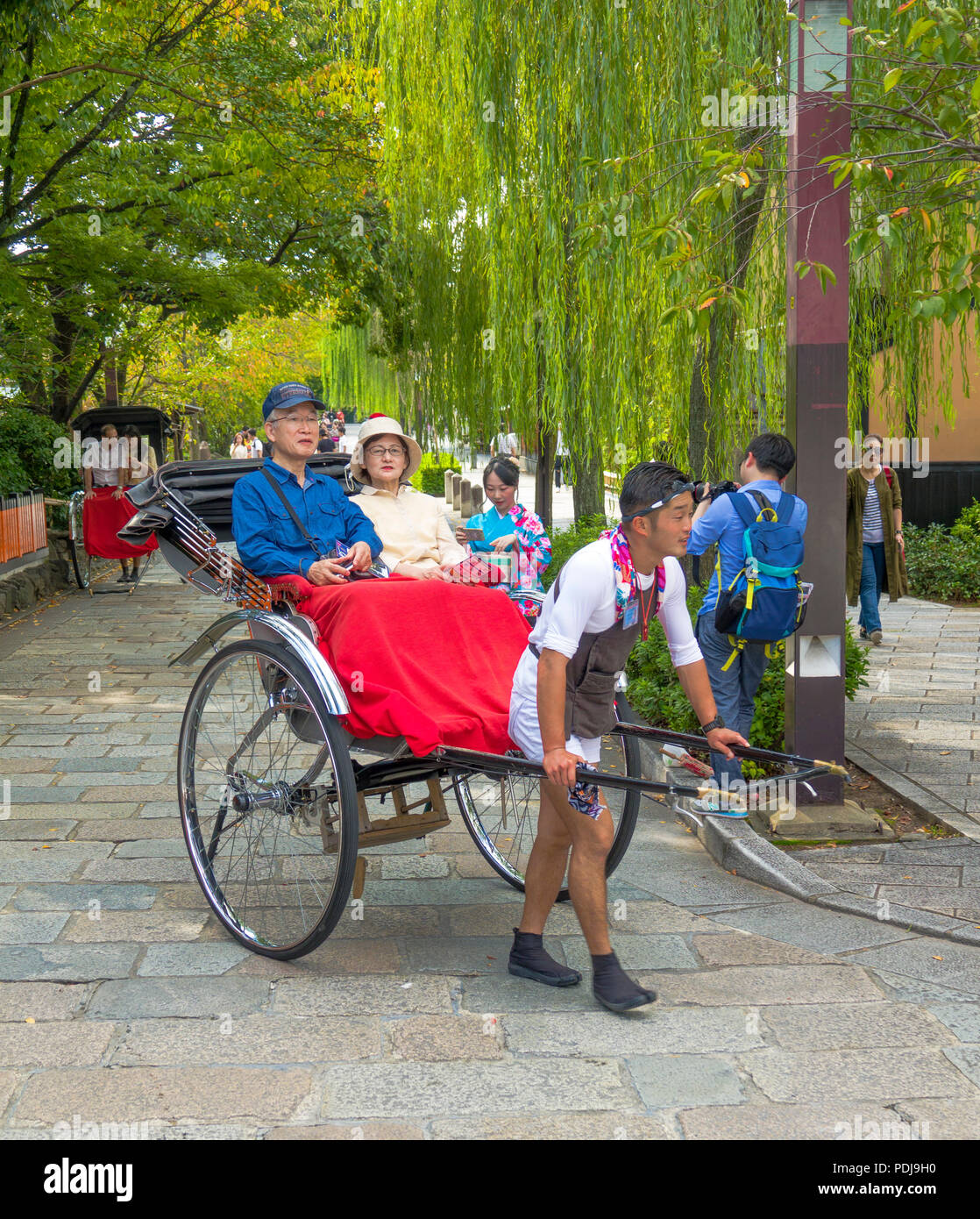 Rickshaw ride in Kyoto Japan park Stock Photo - Alamy