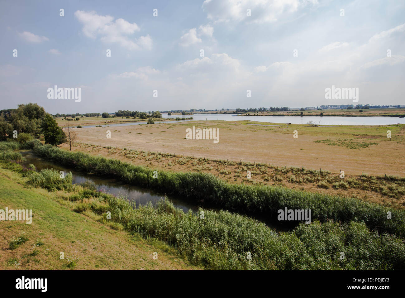 Landscape with water canal in the Netherlands Colorful blue sky with ...