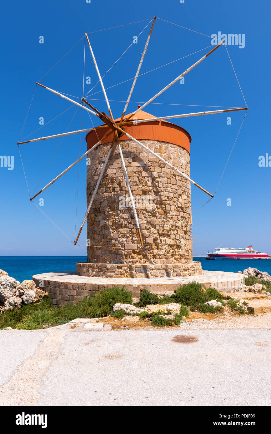Historic windmill overlooking Mandrakia port. Rhodes island, Greece ...