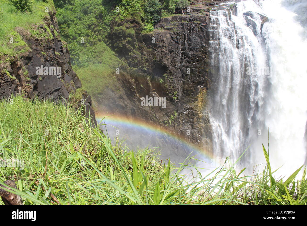 rainbow at the edge of the victor falls in Zimbabwe Stock Photo - Alamy