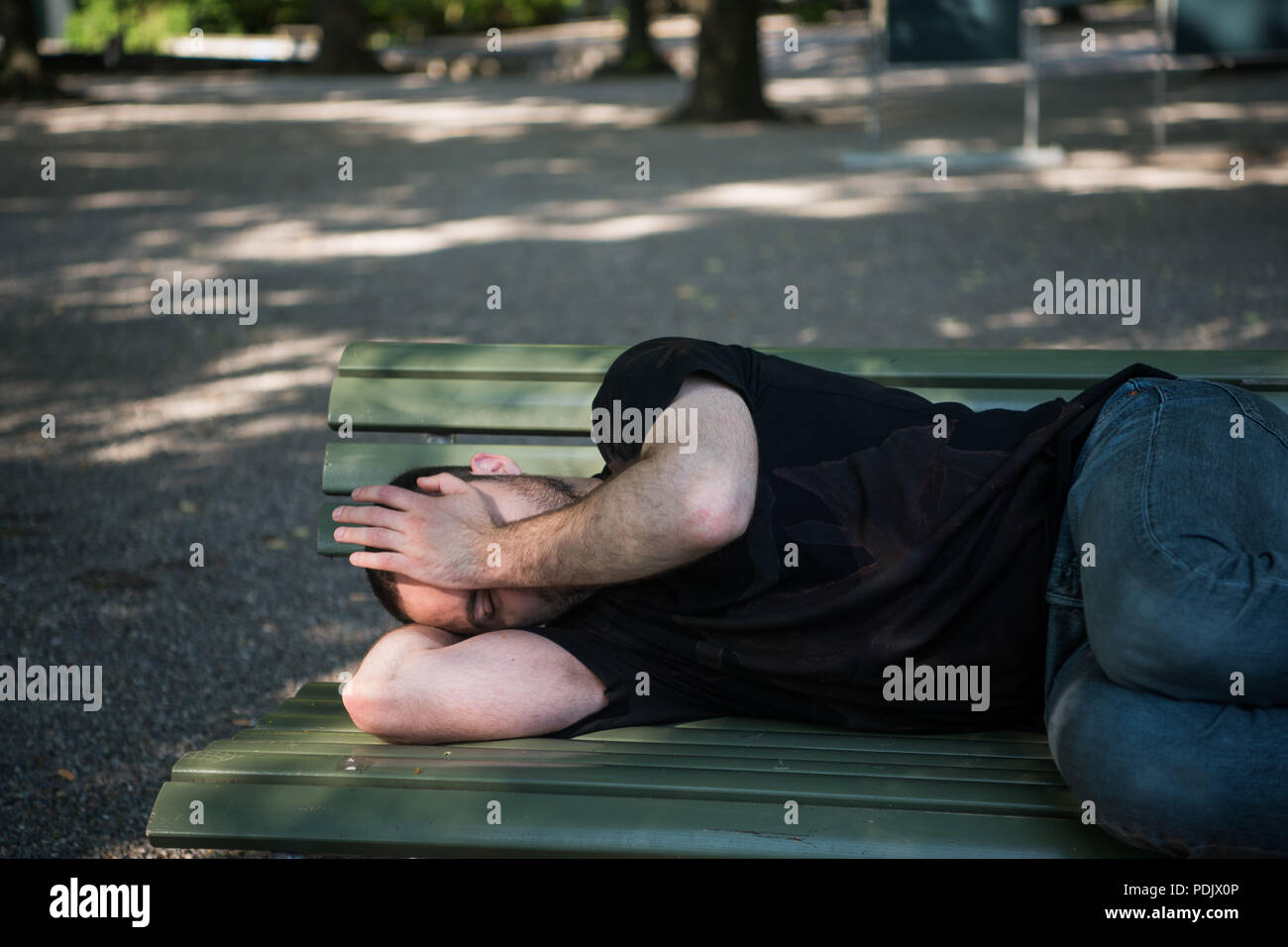 Poor homeless man sleeping on the wooden bench at park Stock Photo - Alamy
