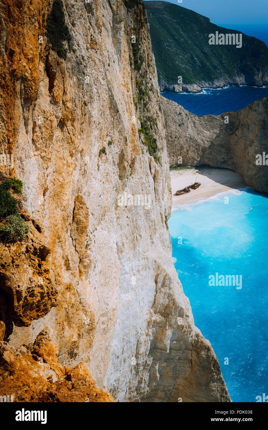 Limestone chalk huge cliff rocks and Navagio beach with abandoned ...