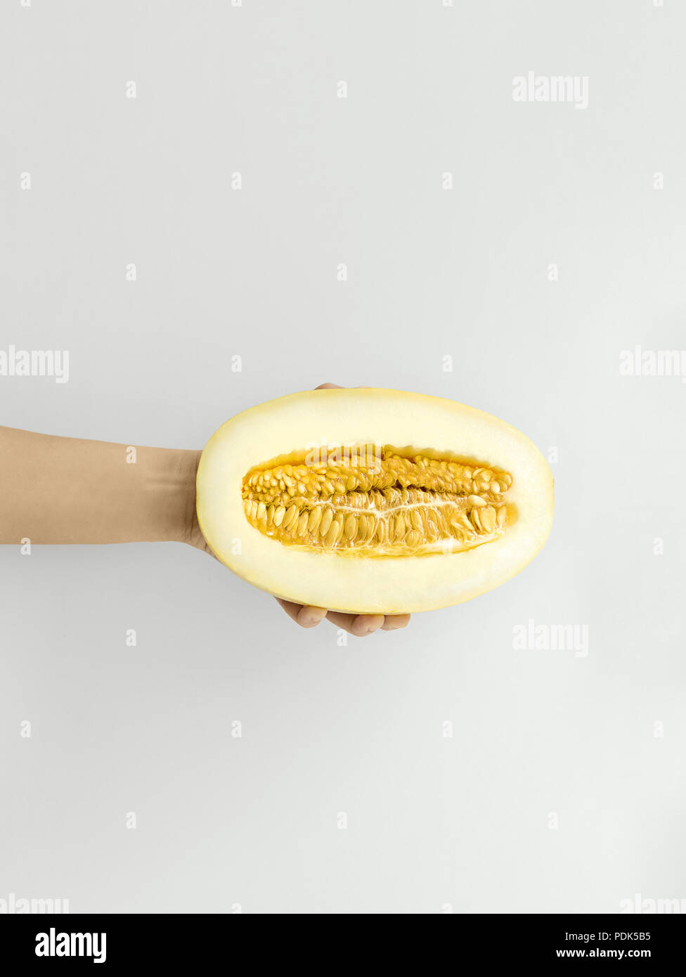 Melon Front view Girl is holding a half of ripe melon against white ...