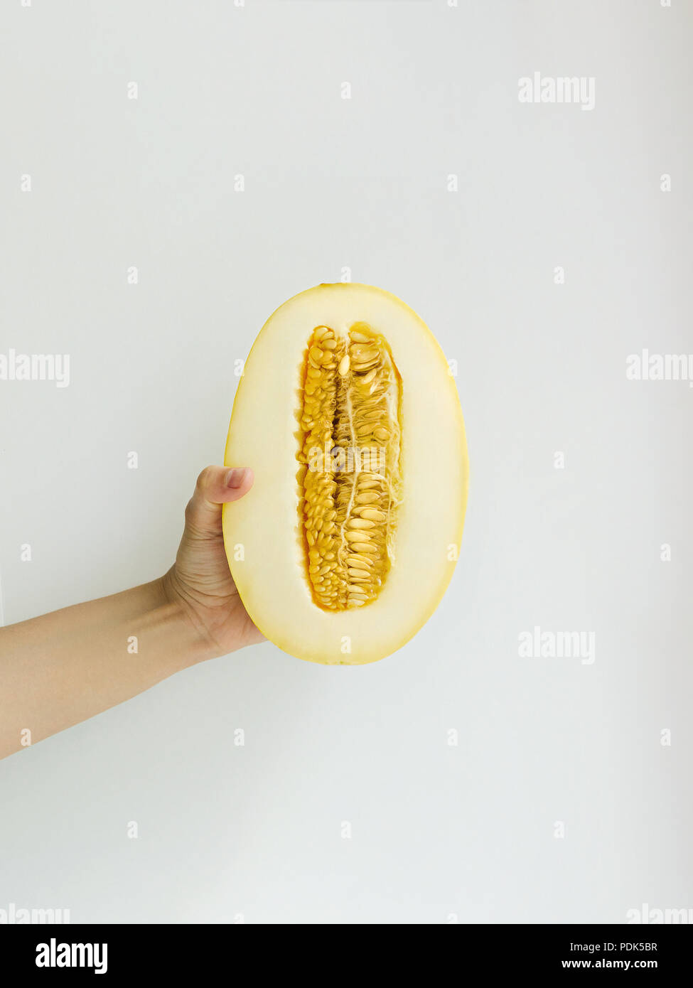Melon Front view Girl is holding a half of ripe melon against white ...