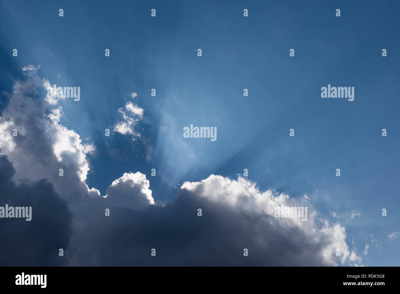 Sun rays behind dark clouds hi-res stock photography and images - Alamy