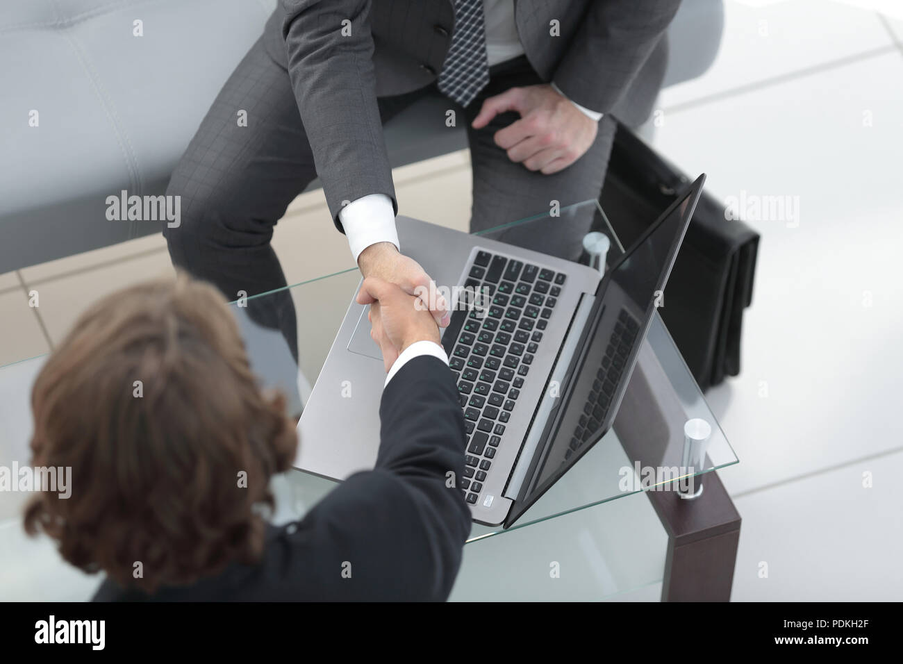 handshake of business partners above the Desk Stock Photo - Alamy